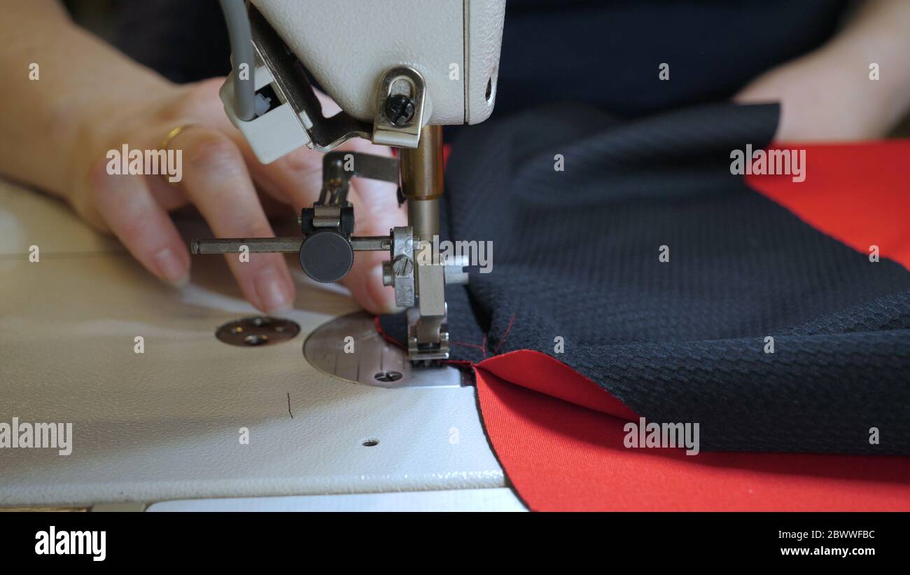 Industrial garment factory, an automatic sewing machine sews various ...