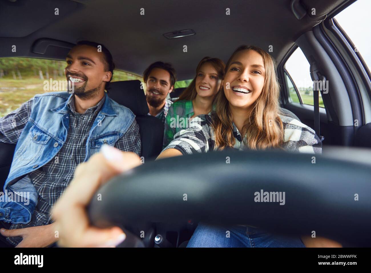A group of happy friends are driving in a car Stock Photo - Alamy