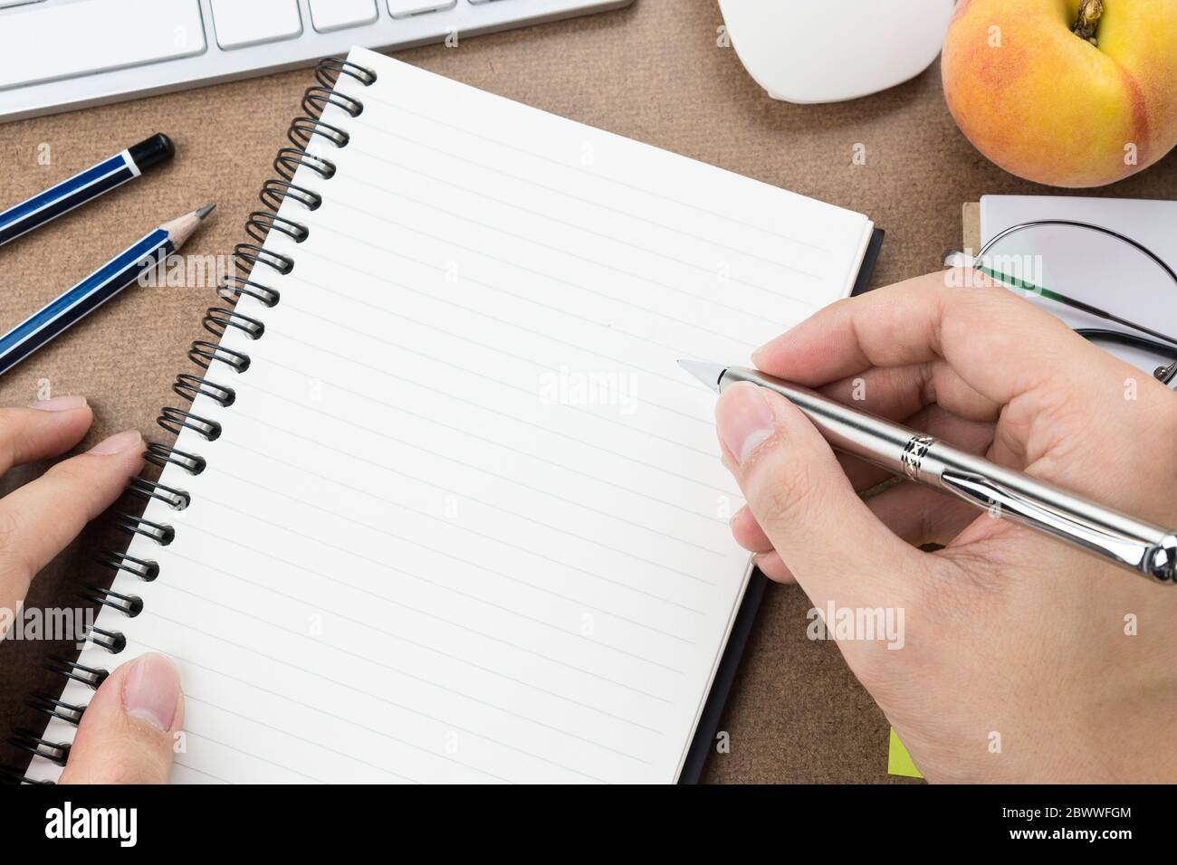 Man is going to write something on blank notebook page Stock Photo - Alamy