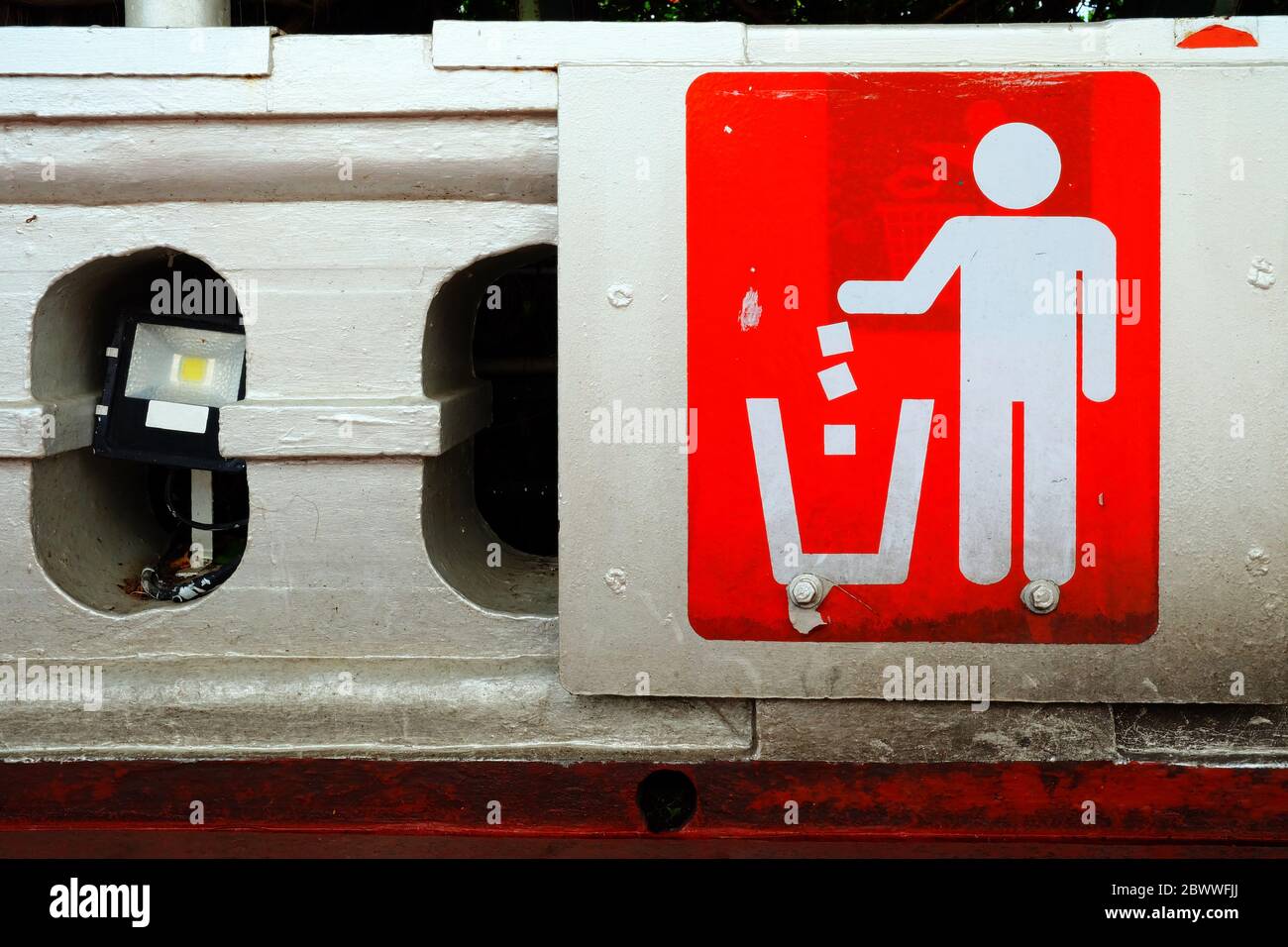 Close up Garbage Disposal Sign on Concrete Fence Stock Photo - Alamy