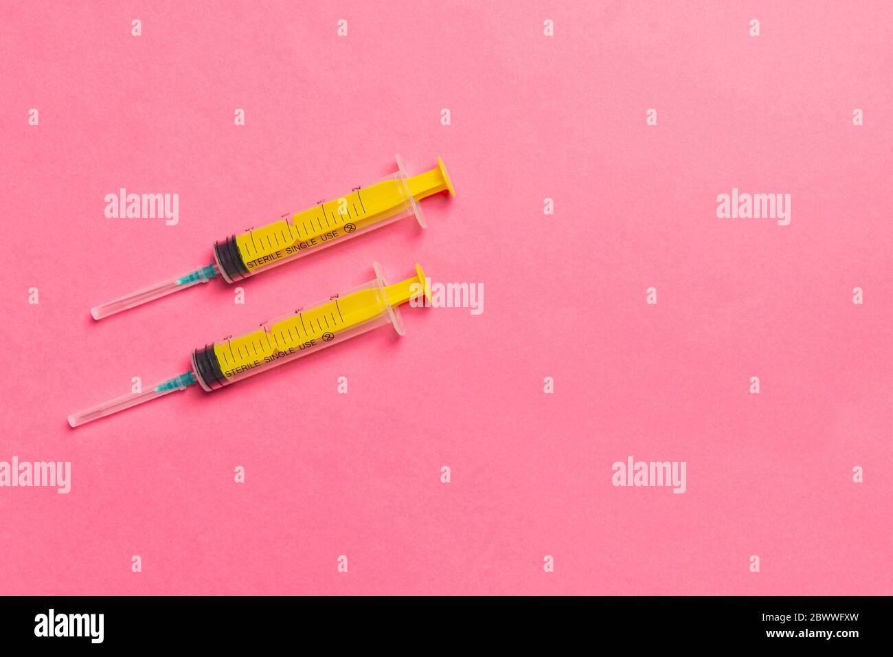 Top view of different syringes for injection on colorful background ...