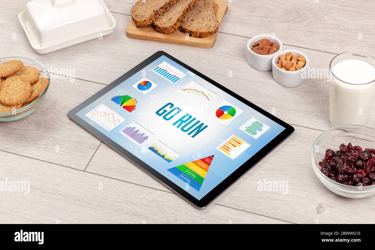 Organic food and tablet pc showing GO RUN inscription, healthy ...
