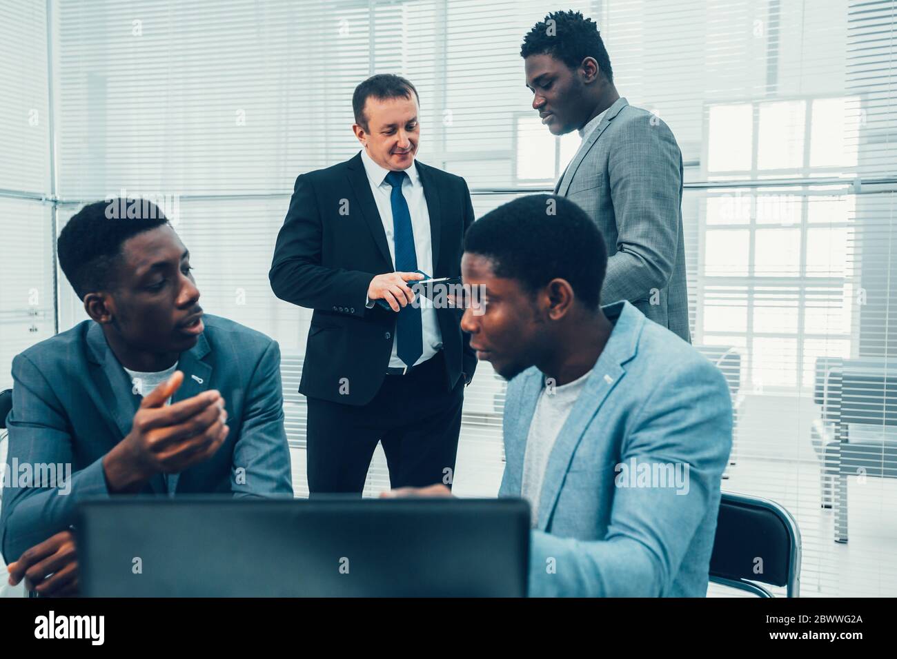 multinational business team works in the office Stock Photo - Alamy