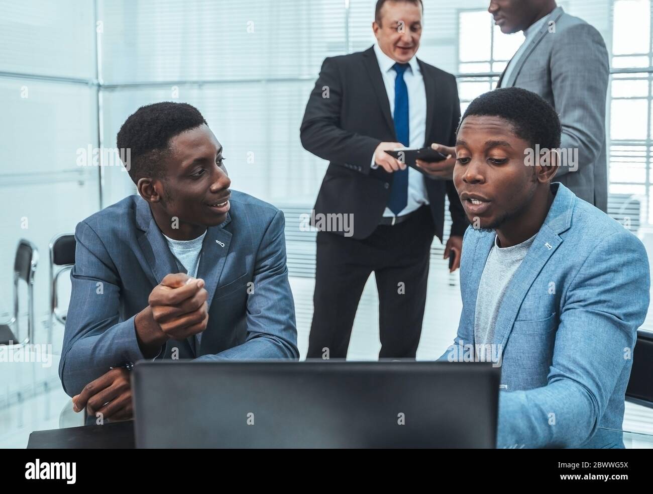 multinational business team works in the office Stock Photo - Alamy