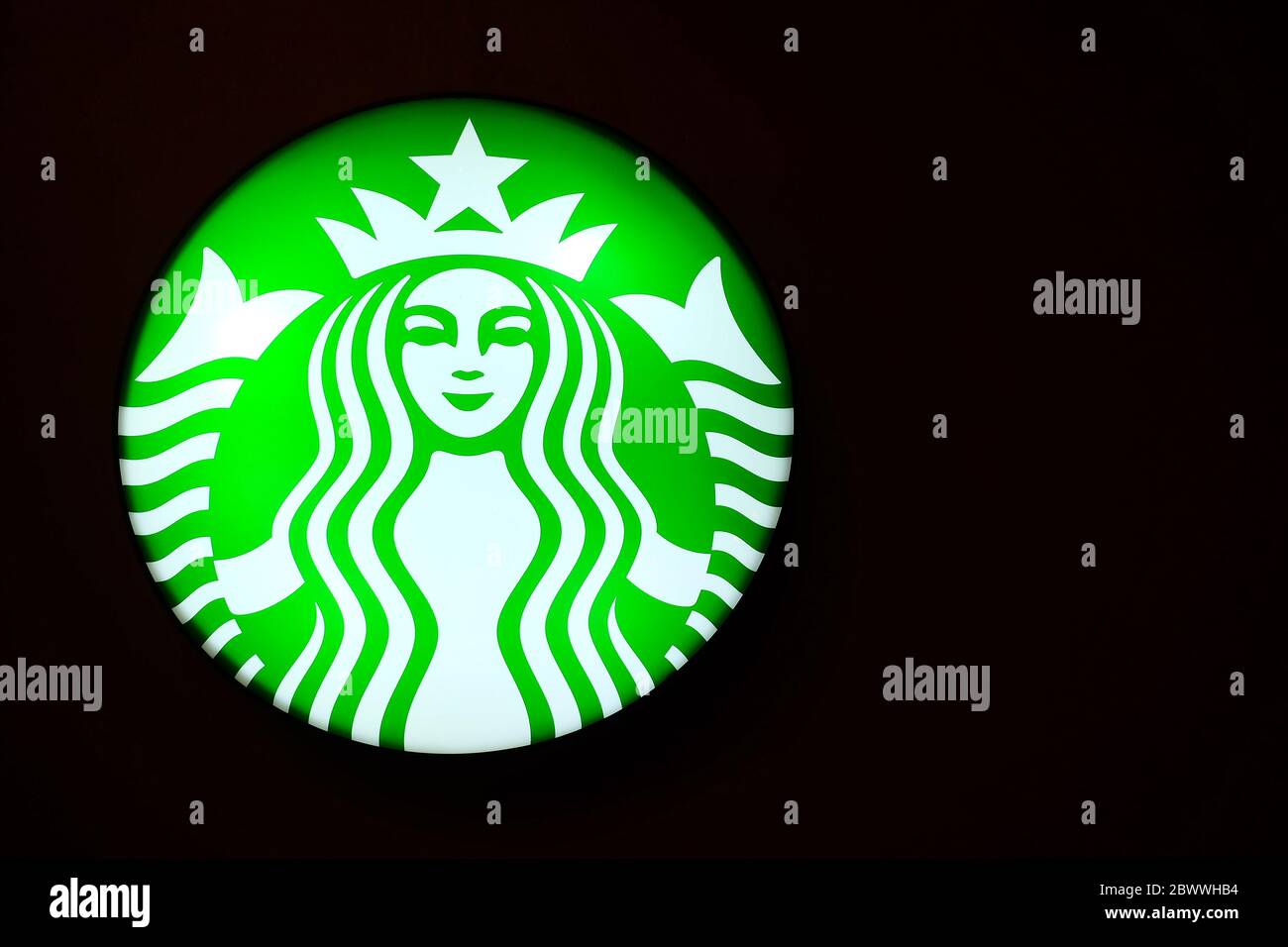 BANGKOK, THAILAND - DECEMBER 13, 2018: Starbucks light sign on green ...