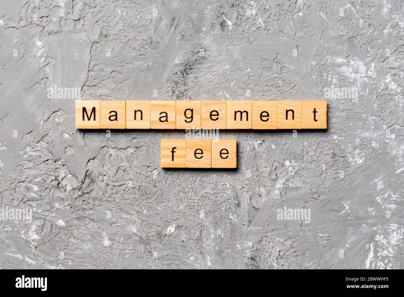 management fee word written on wood block. management fee text on ...