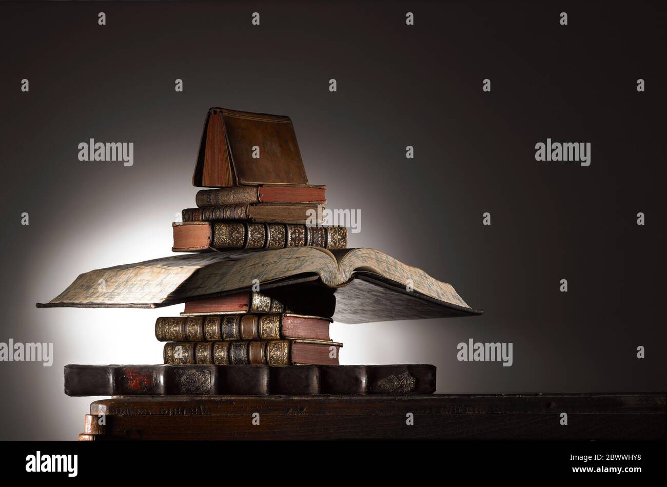 Pile of ancient books on a table Stock Photo - Alamy