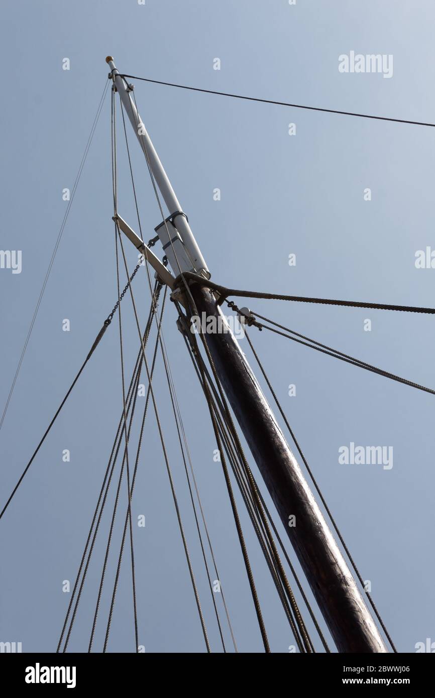 Tall ship mast with rope rigging lines, block and tackle, against a ...