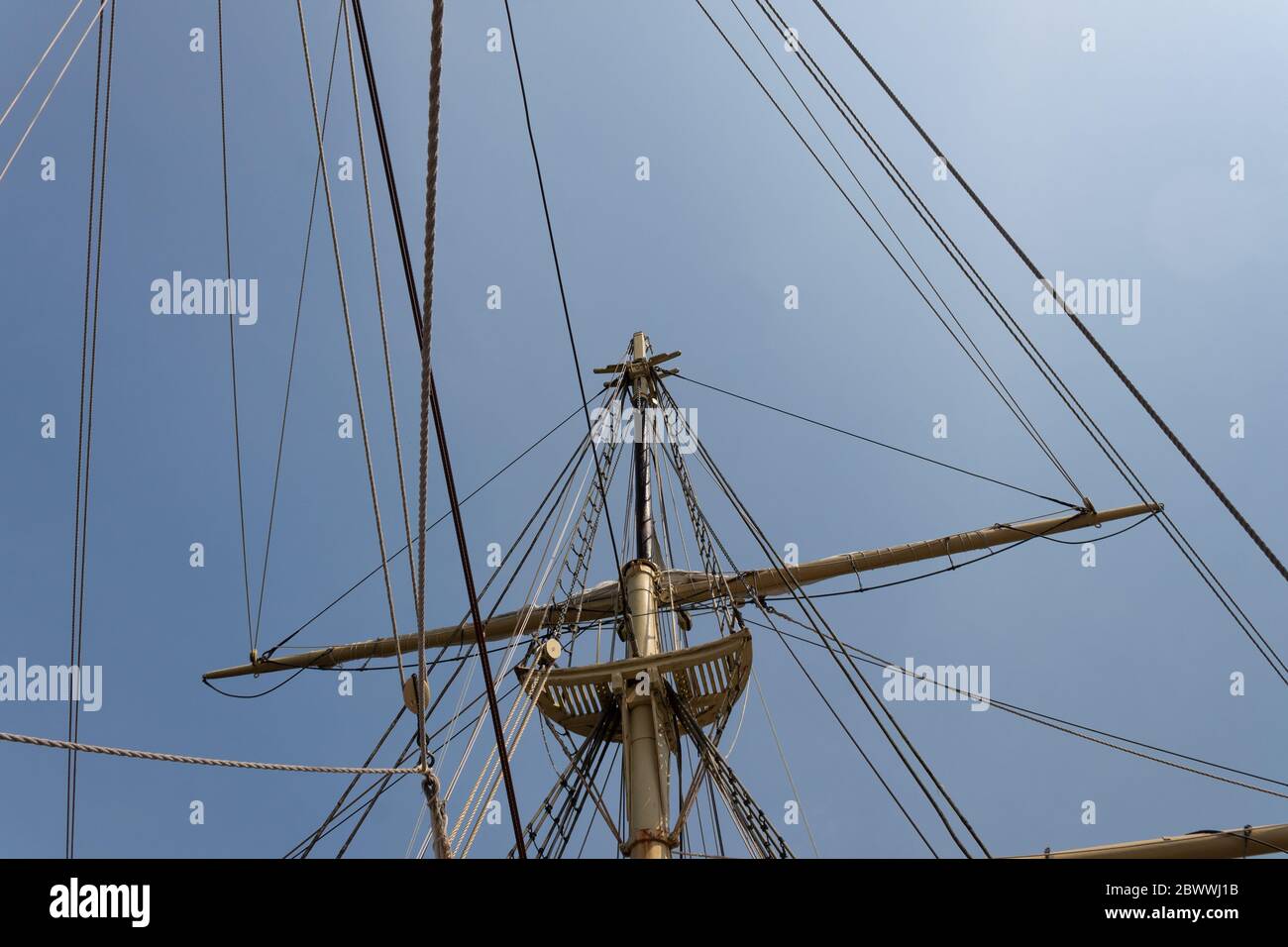 Top of mast on a vintage sailing vessel with ropes, lines, and shrouds ...