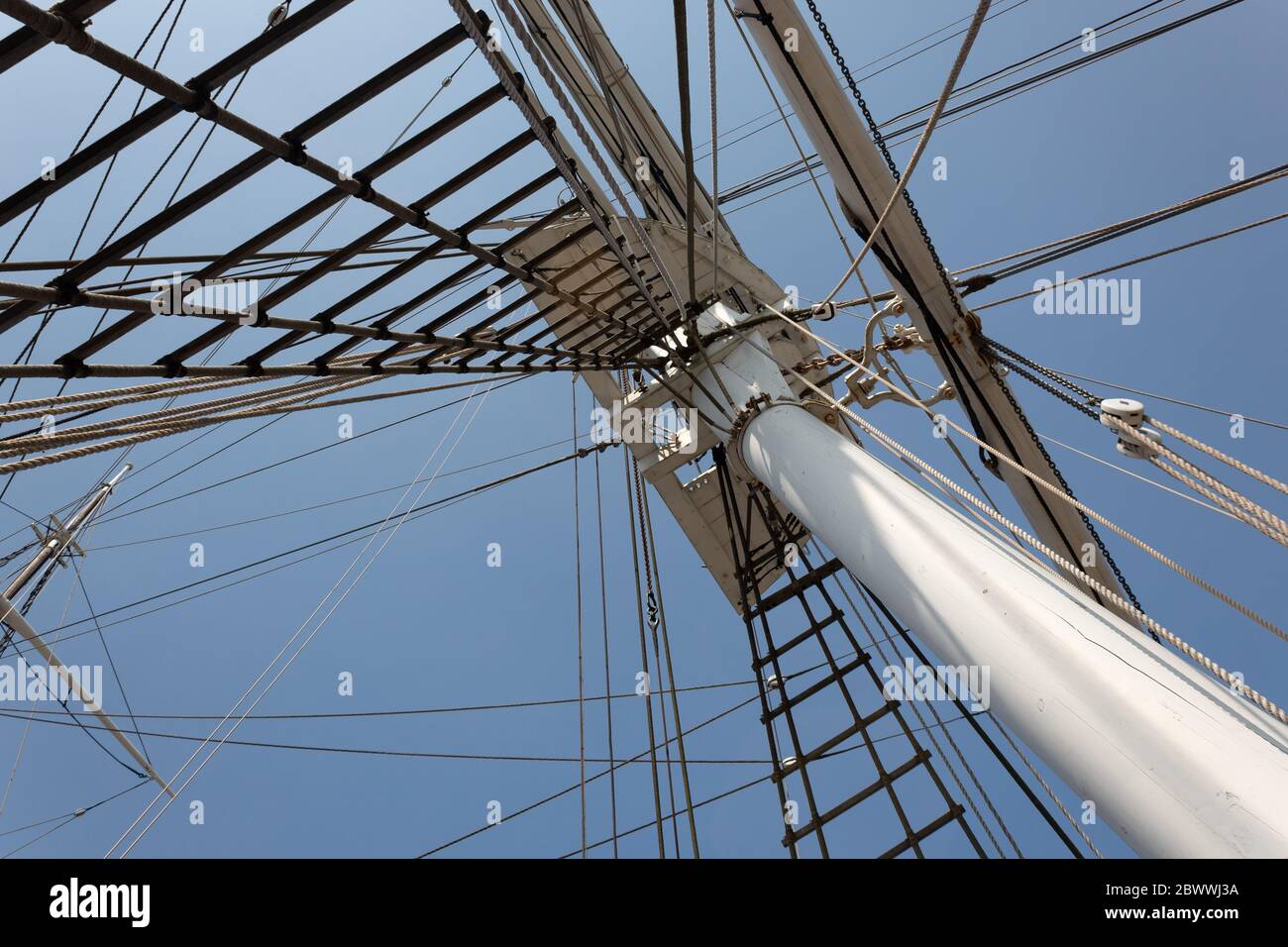 View up the mast of a tall sailing ship with shrouds, ropes, block and ...