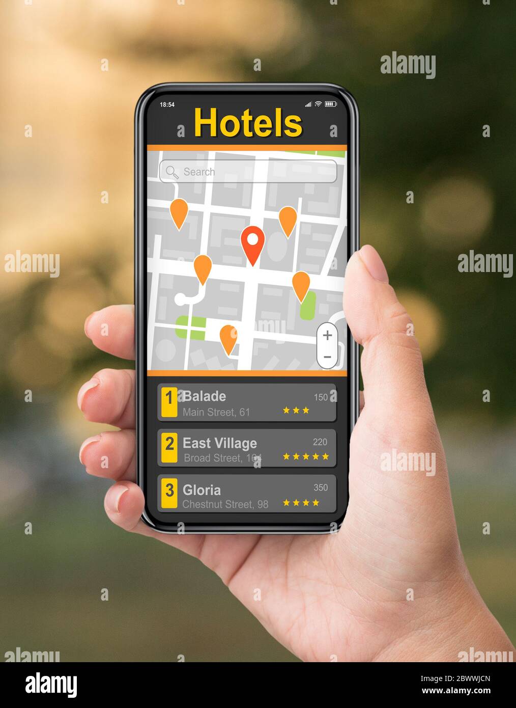 Tourist using map in cellphone to navigate and find hotel locations in ...