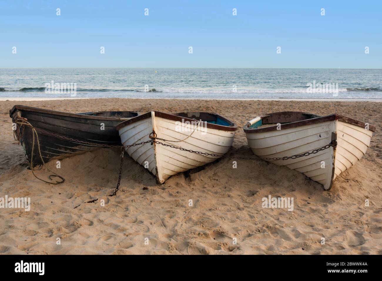 Fishing rowing boats on Bournemouth beach Stock Photo - Alamy