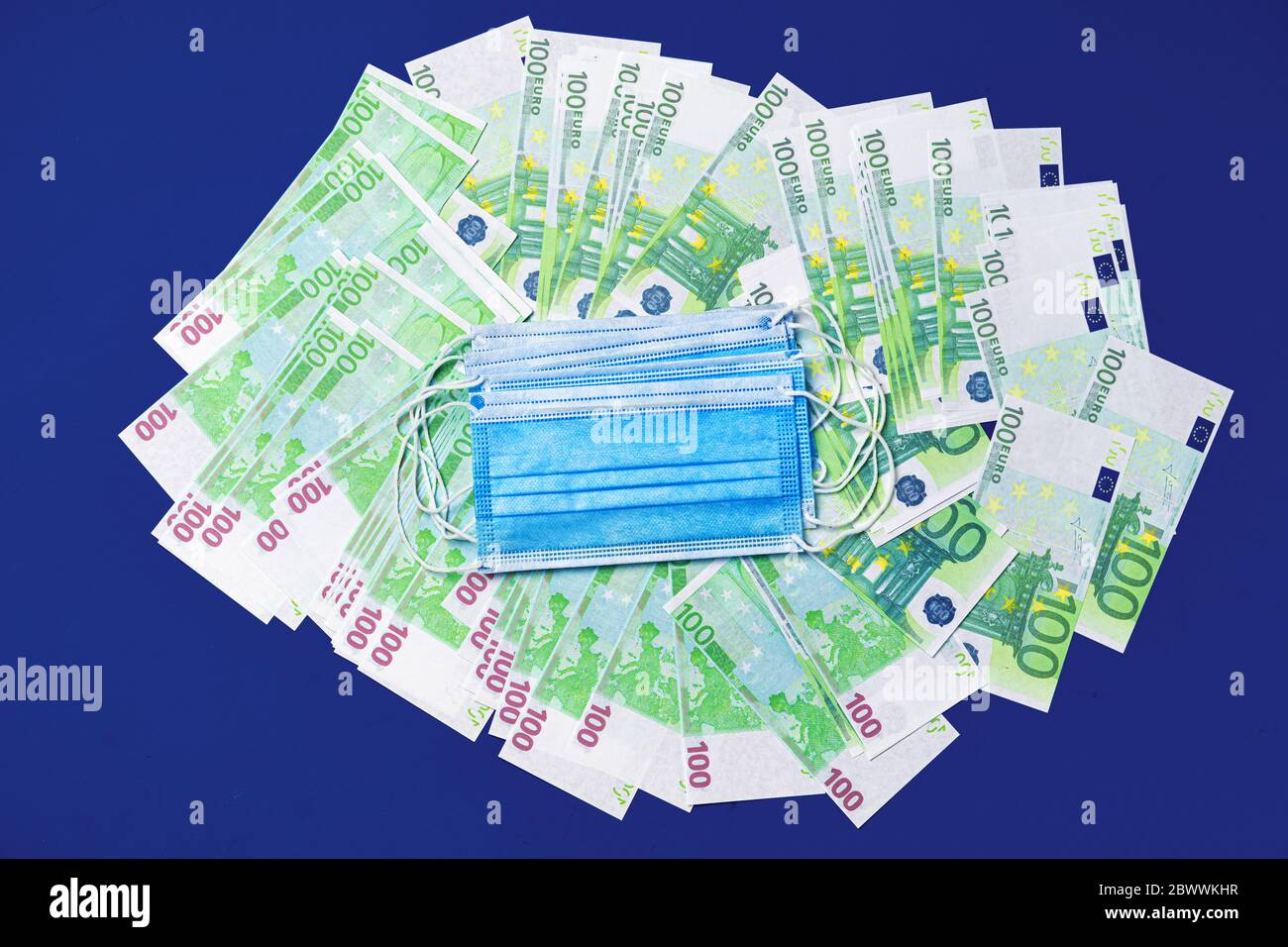 Protective face masks on background of Euro banknotes Stock Photo - Alamy