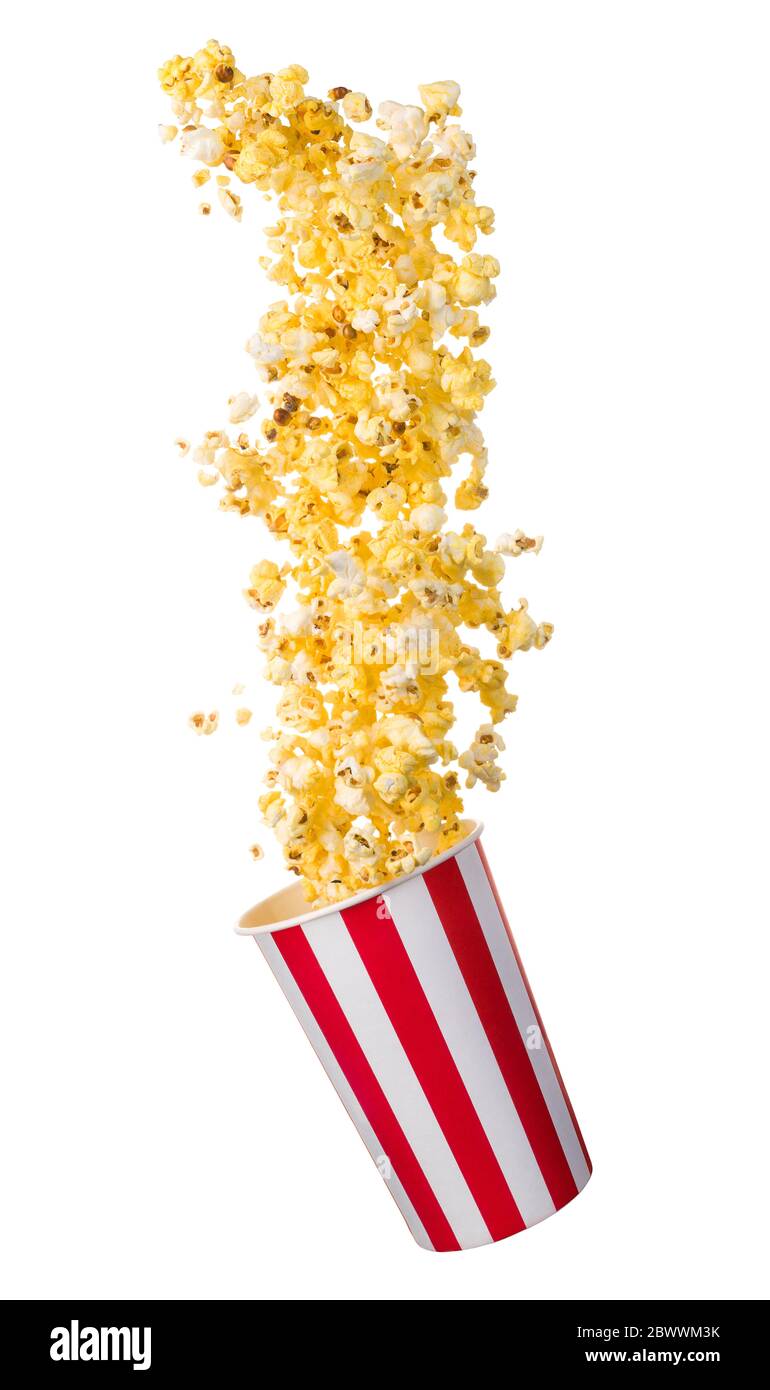 Flying popcorn from paper striped bucket isolated on black background ...
