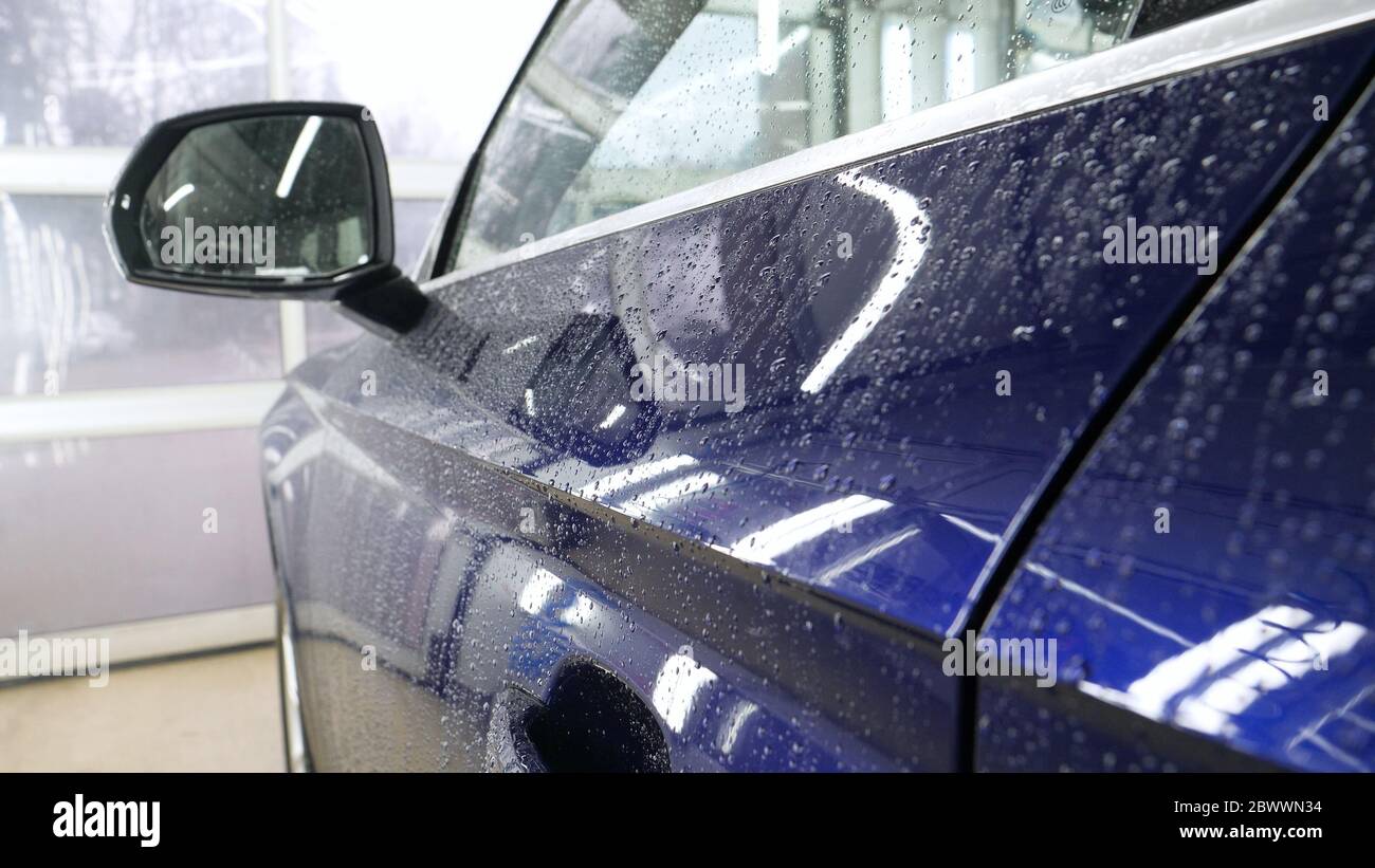 Paint protection film installation on side panel surface of luxury ...