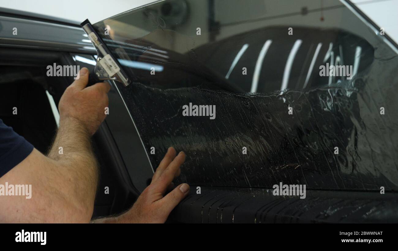 Paint protection film installation on side panel surface of luxury ...