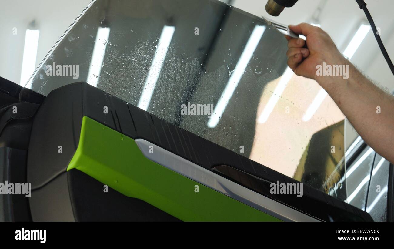 Paint protection film installation on side panel surface of luxury ...