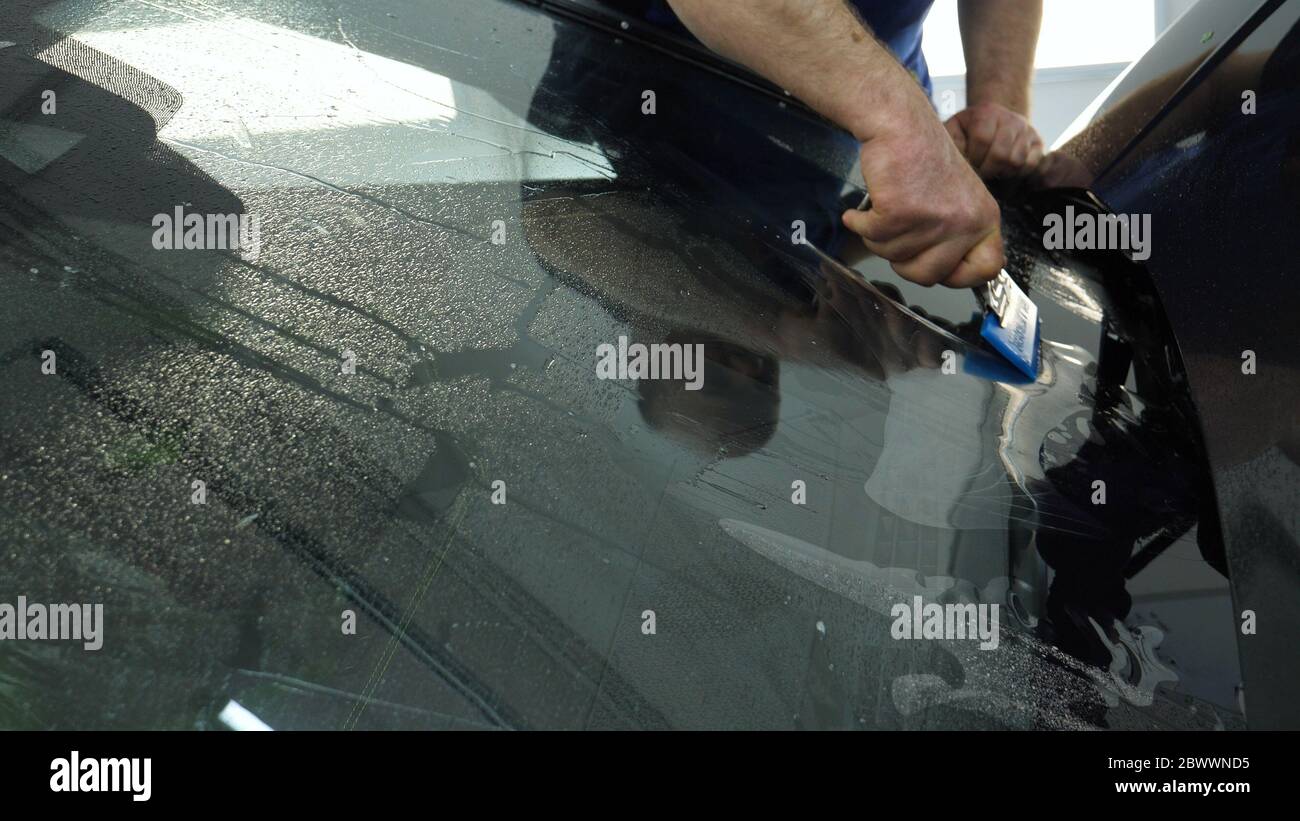 Paint protection film installation on side panel surface of luxury ...