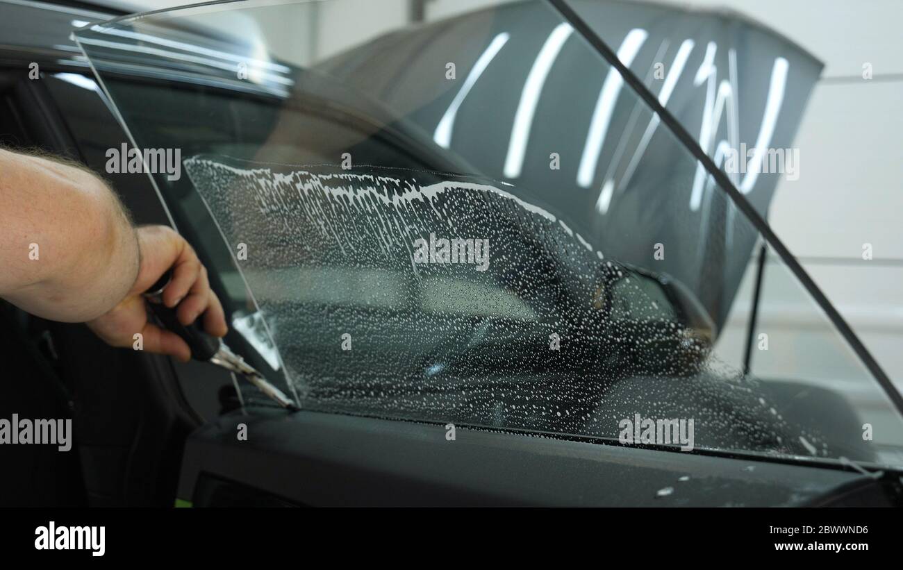 Paint protection film installation on side panel surface of luxury ...