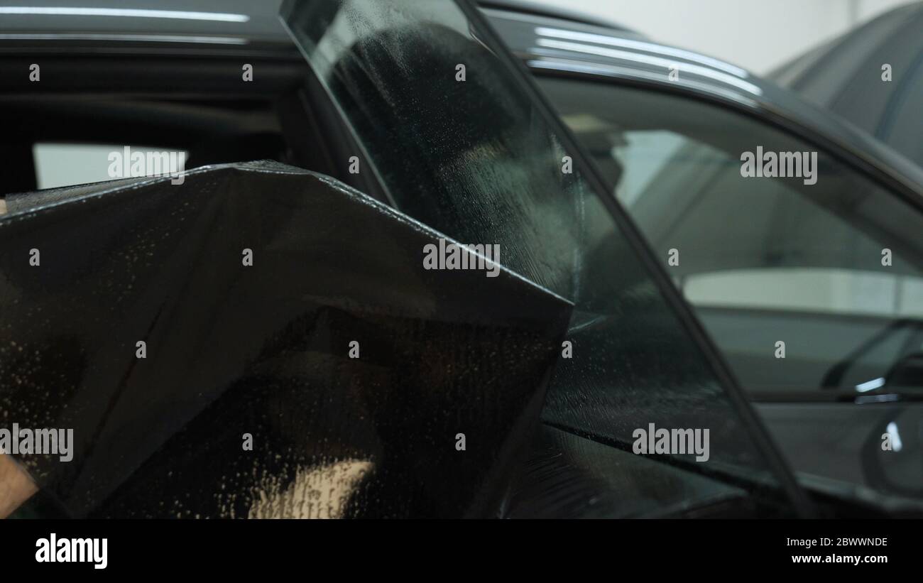 Paint protection film installation on side panel surface of luxury ...