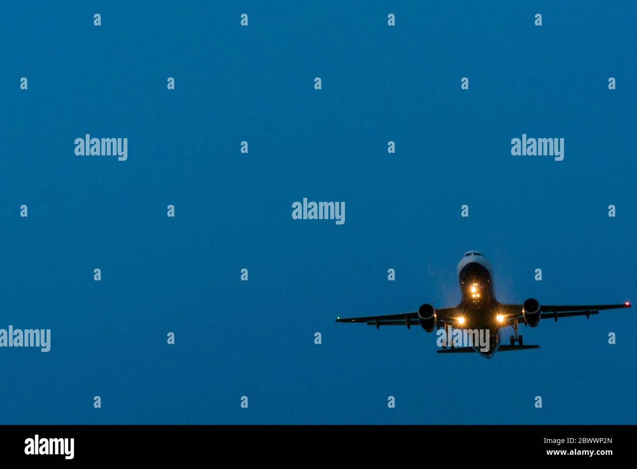 Airplane immediately after take off from airport, sky view at night ...