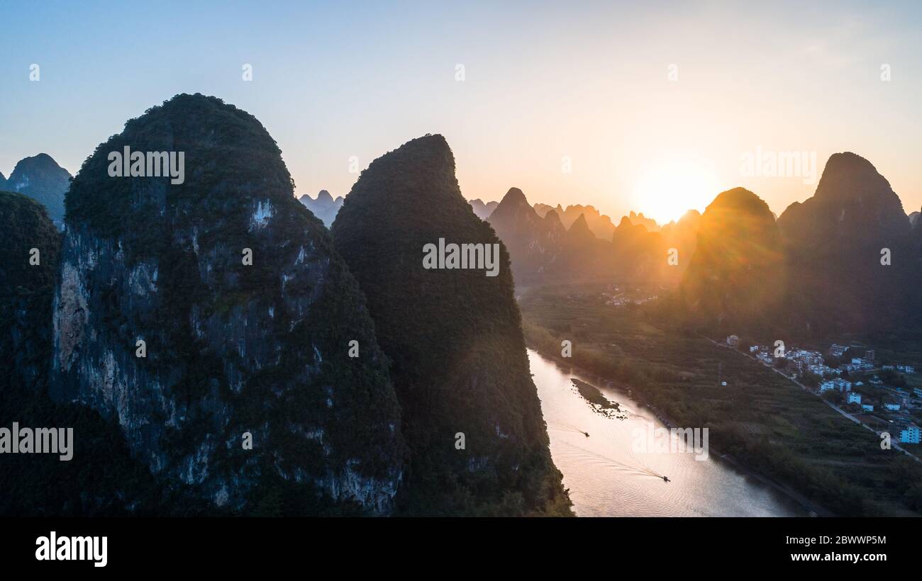 sunset on a river with karst mountains Stock Photo - Alamy