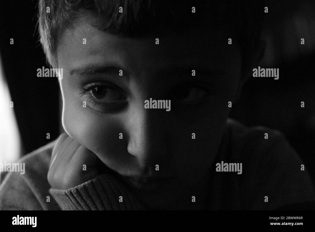 Portrait of a young boy contemplating Stock Photo - Alamy