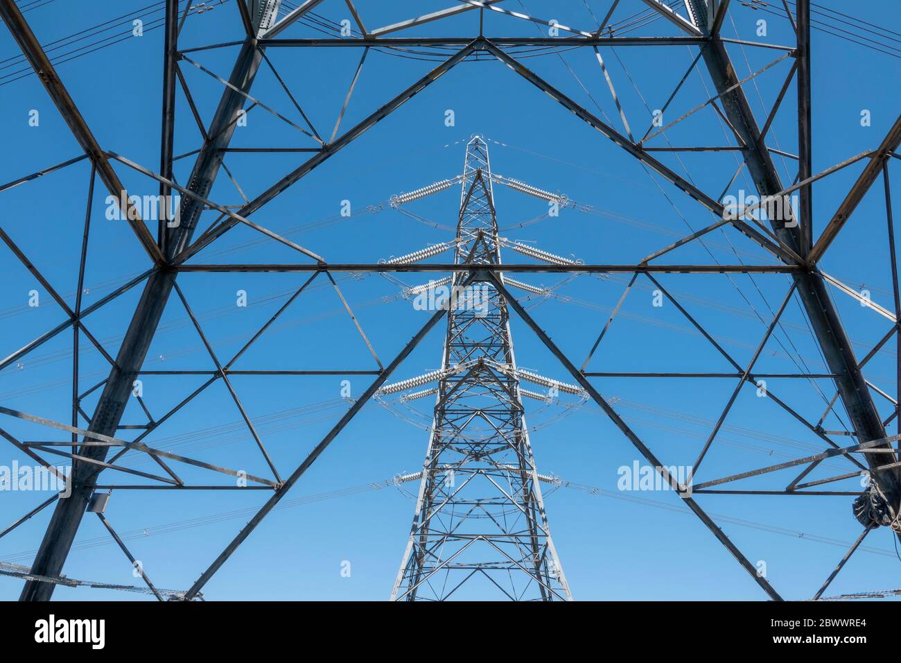 A high voltage electricity pylon seen through a close up of the lattice ...