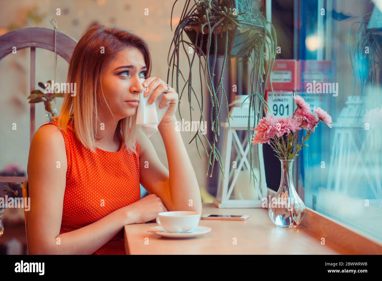 Misery, infelicity. Brunette woman girl crying wiping tears sneezing in ...