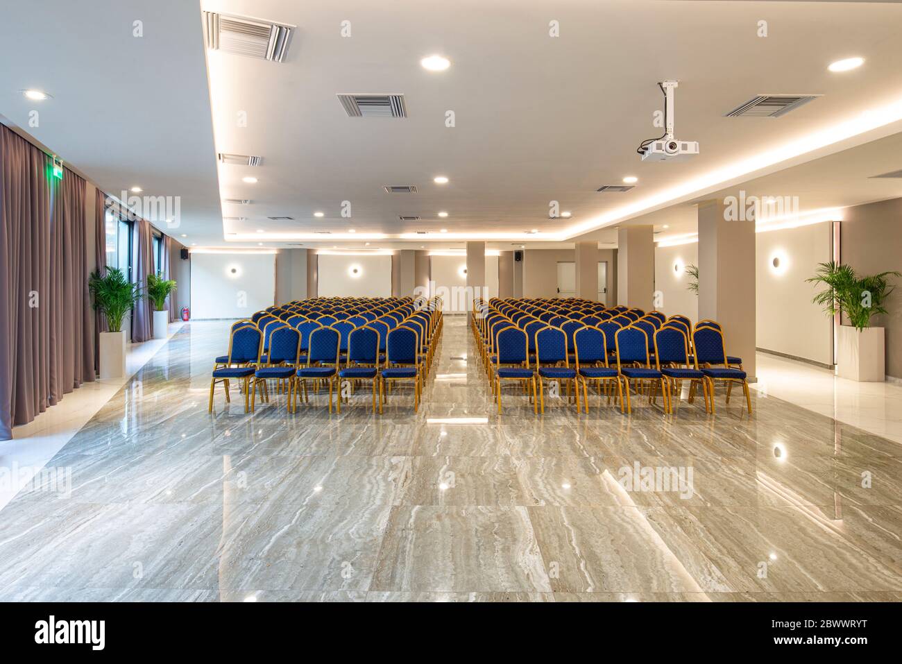 Rows of vintage blue chairs on beige glossy marble floor in modern ...
