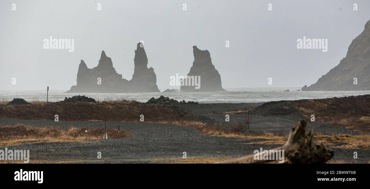 Reynisdrangar basalt sea stacks (troll rocks) on the black volcanic ...