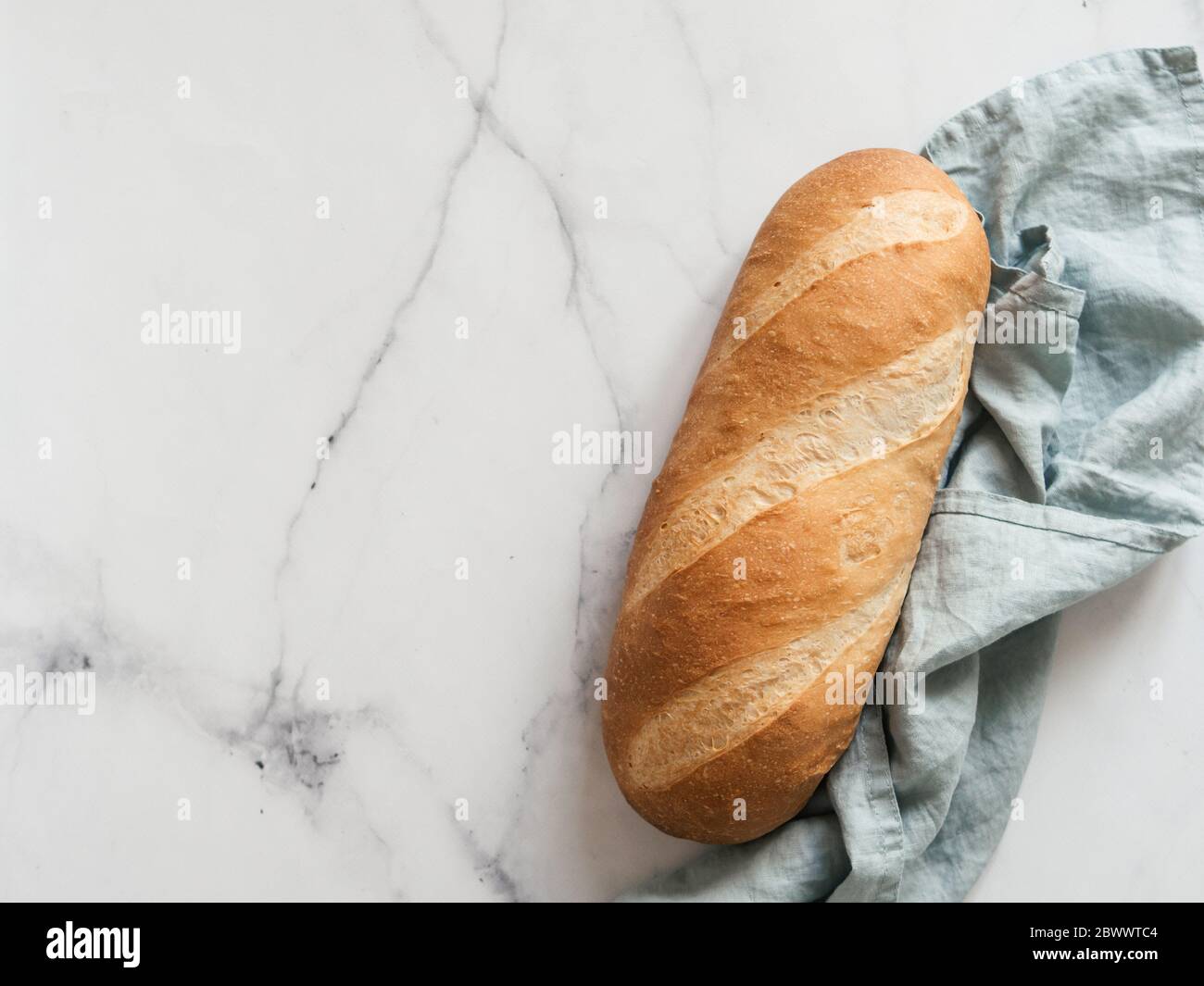 British White Bloomer or European Baton loaf bread on white marble ...