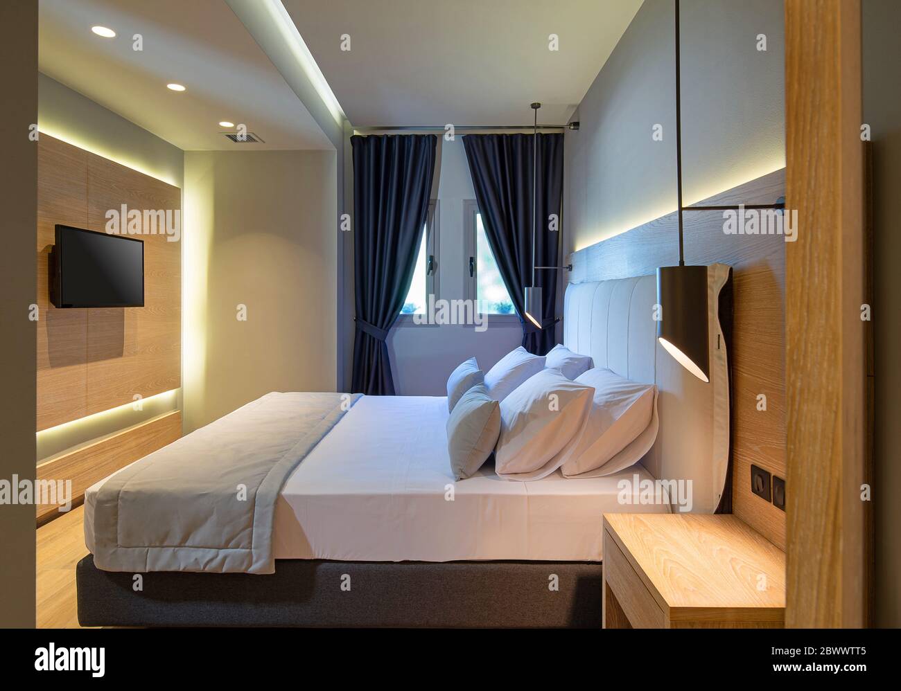 Side view of modern bedroom interior with wooden panel, flat tv ...