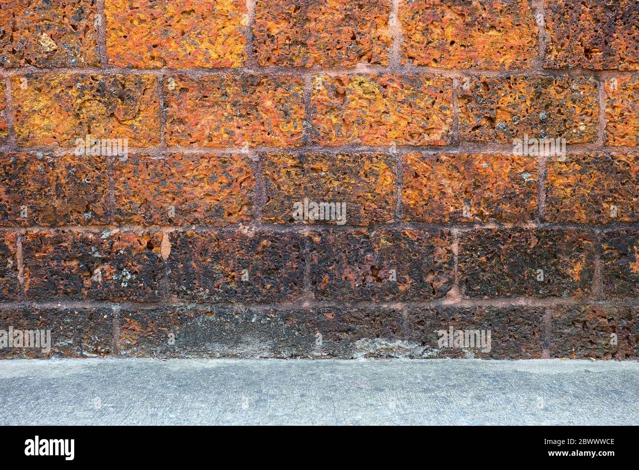 Laterite Brick Wall Texture Background with Concrete Ground Stock Photo ...