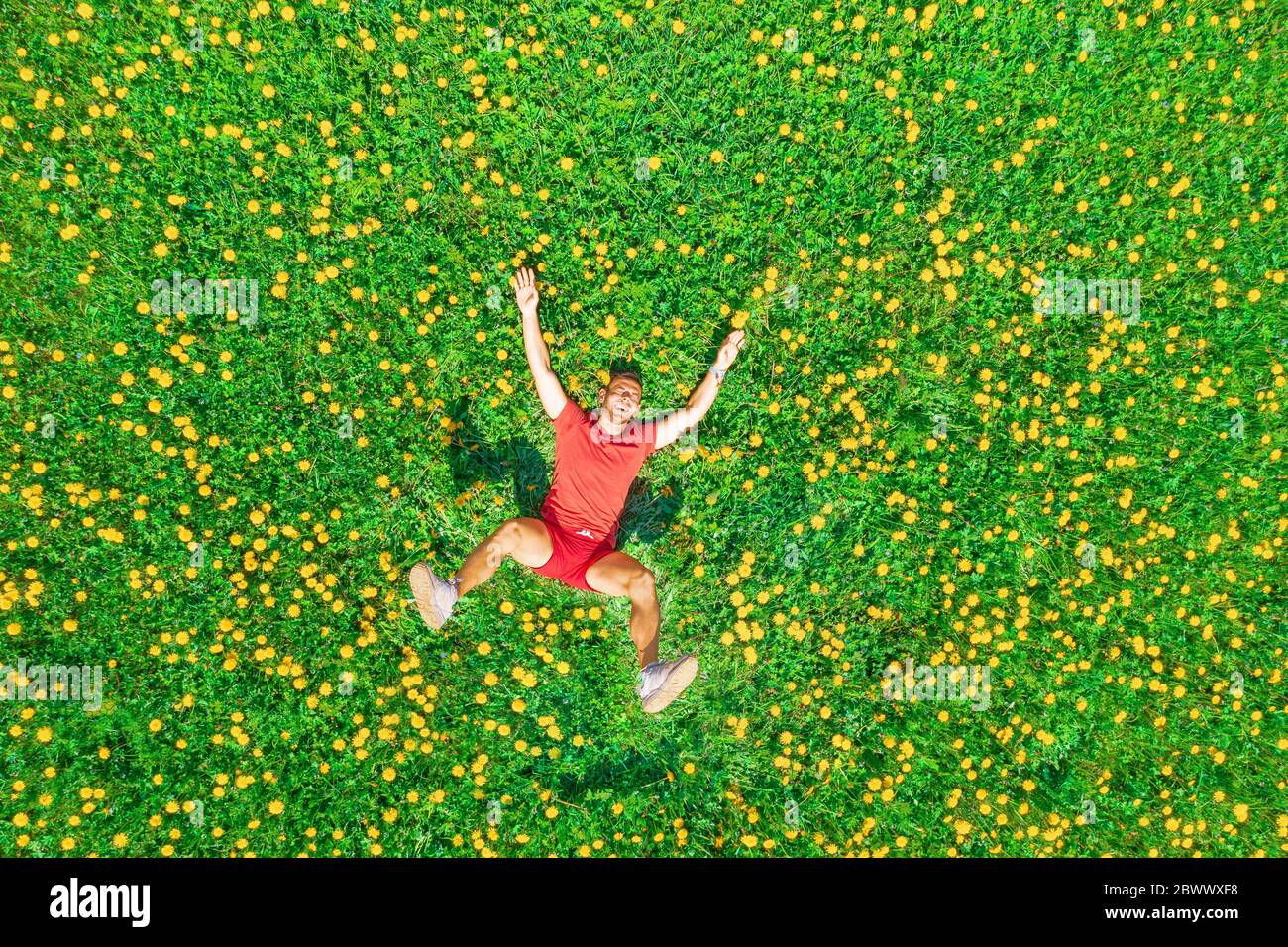 Happy smiling man happy smiling and laughing lying in bright red and ...