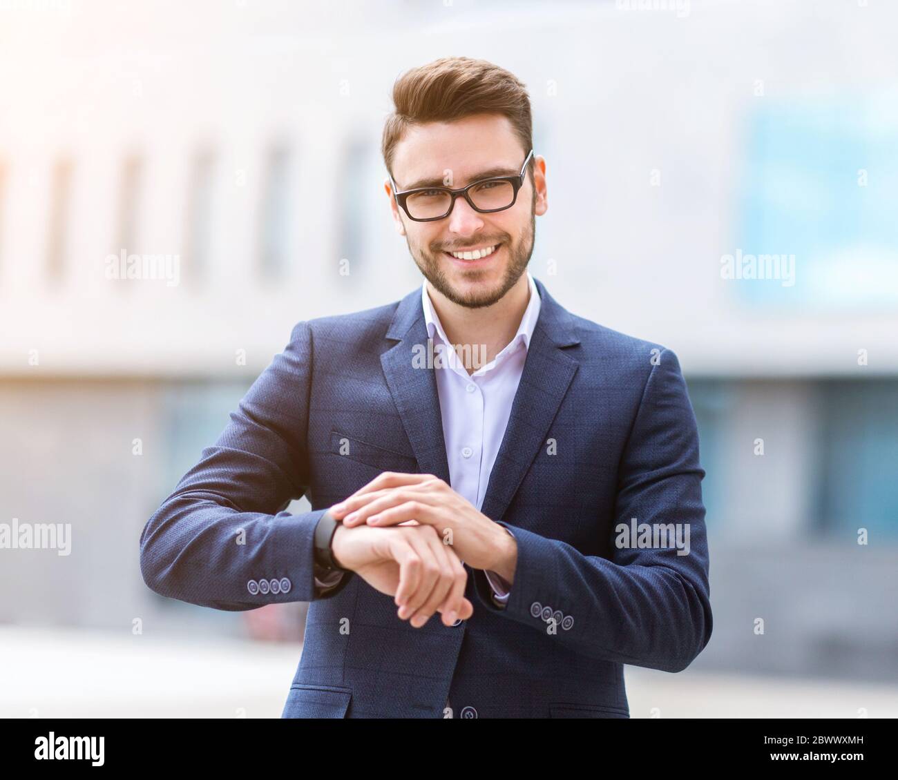 Smiling government official in business suit checking time on his watch ... Smiling government official in business suit checking time on his watch ...