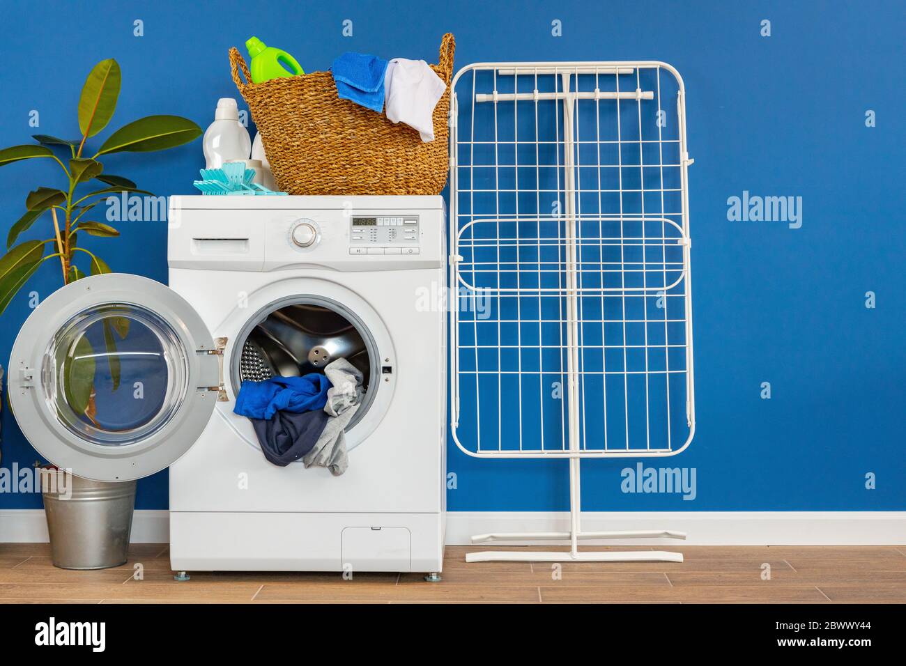 Laundry room interior with washing machine and clothes dryer near wall ...