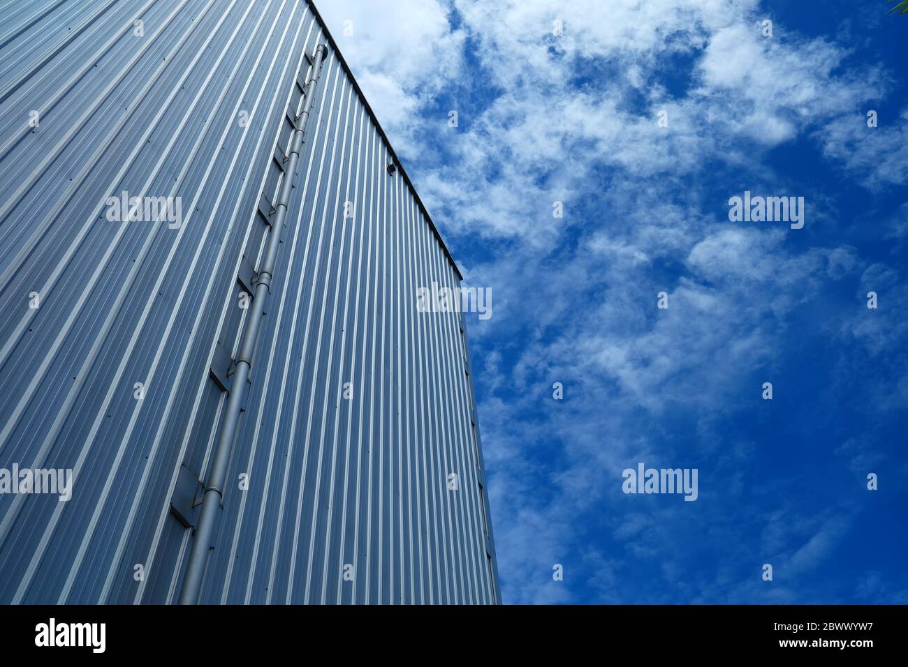 Warehouse Wall with Blue Sky Background Stock Photo - Alamy