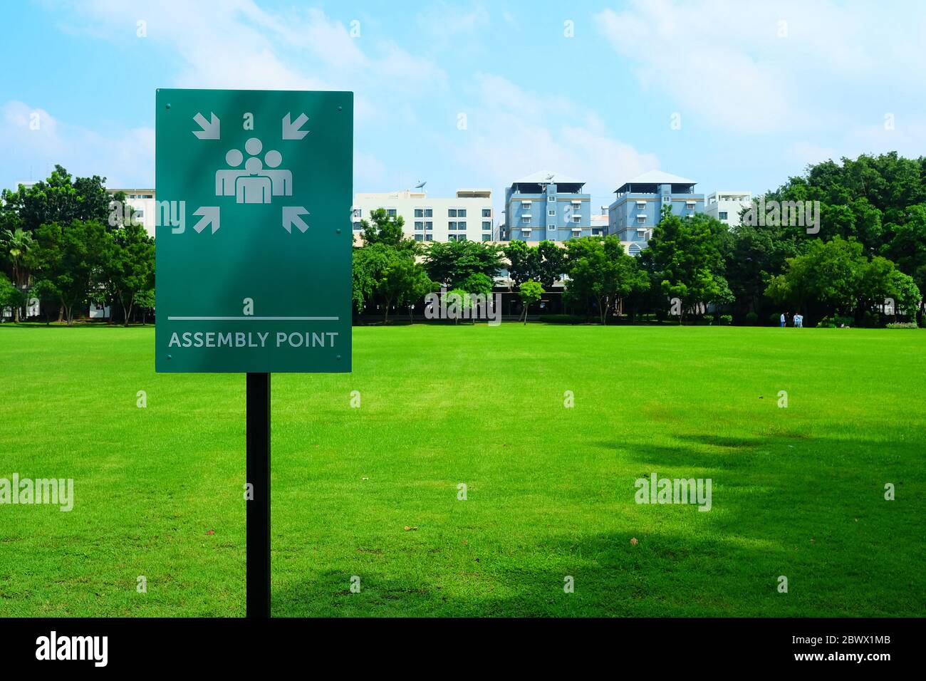 Assembly Point Sign with Green Grass Field Background Stock Photo - Alamy