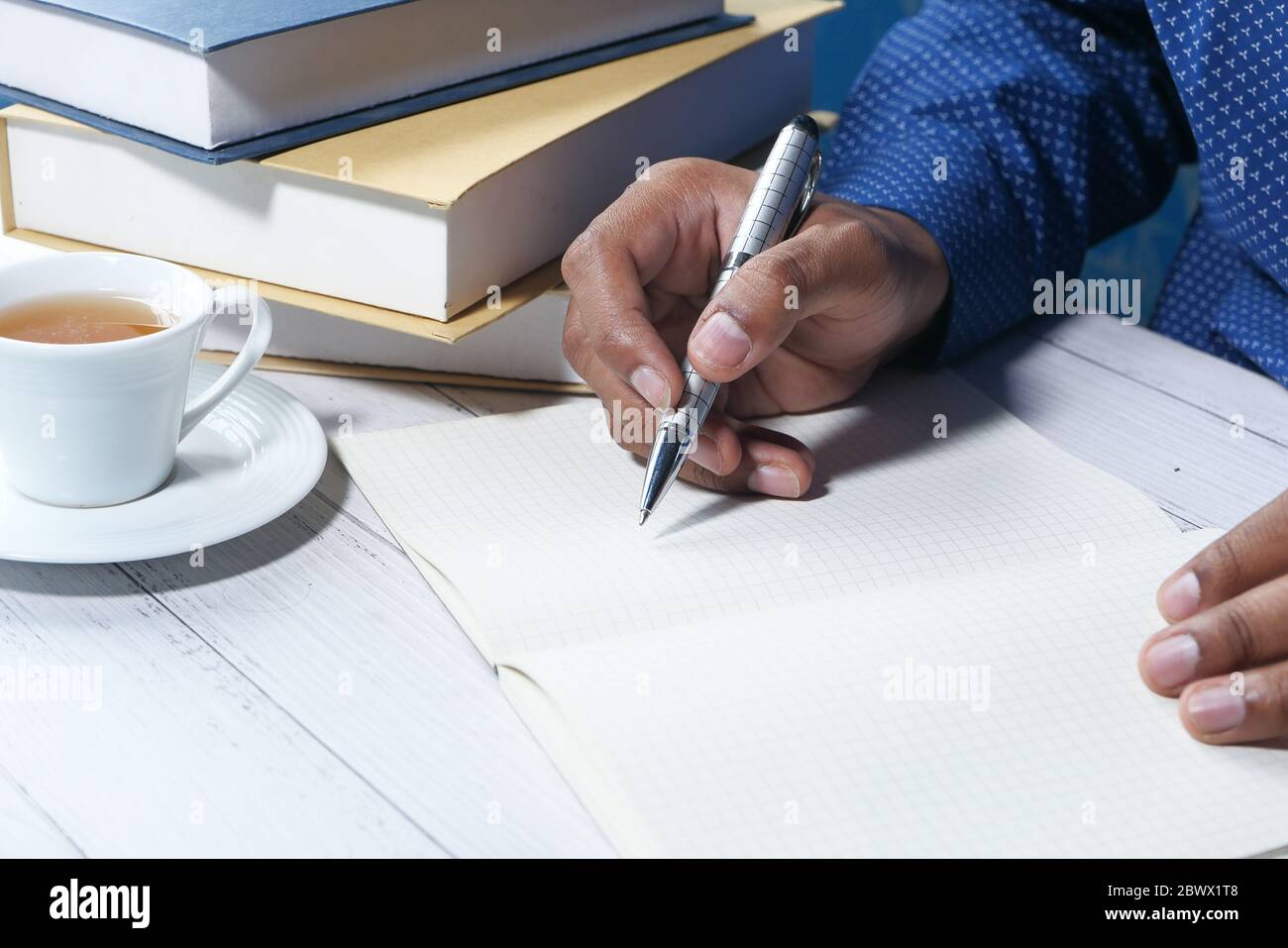 male hand writing in notebook with pen Stock Photo - Alamy