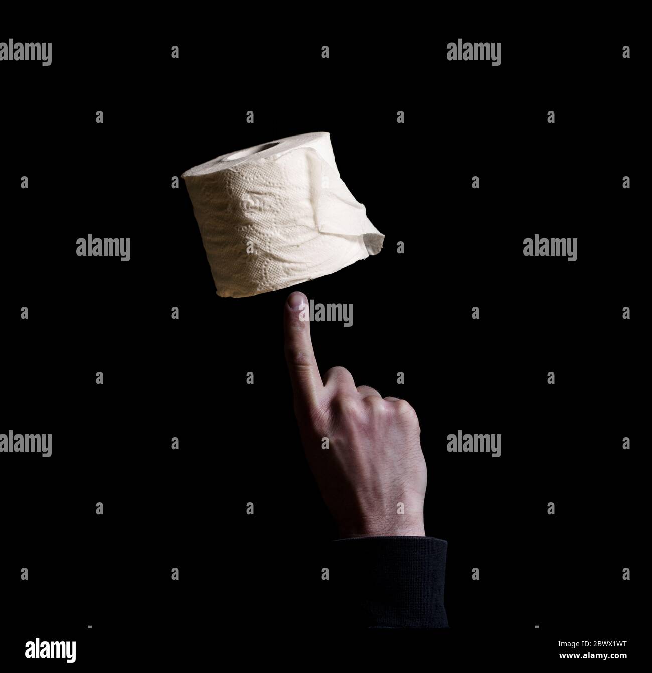 Toilet paper rotating on finger basketball spin of white roll of loo ...