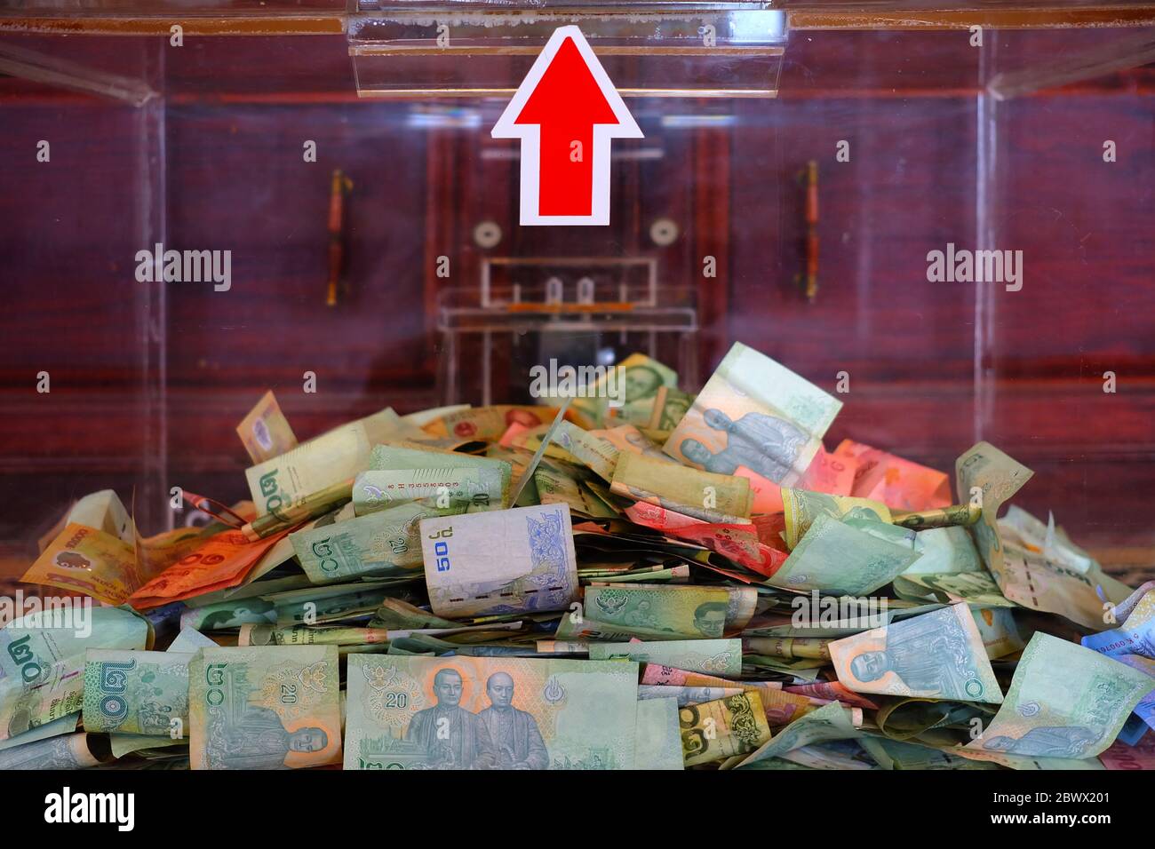 Person putting money in charity box hi-res stock photography and images ...