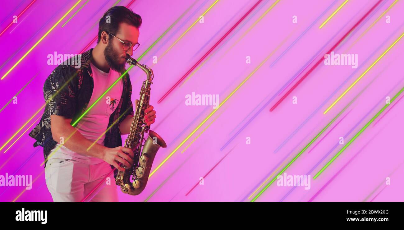 Musician with saxophone impovising. Creative portrait with copyspace ...
