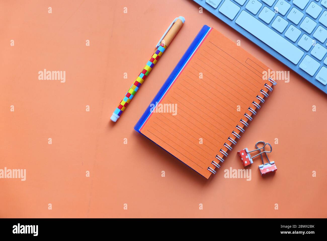 orange notepad, keyboard and pen with copy space Stock Photo - Alamy