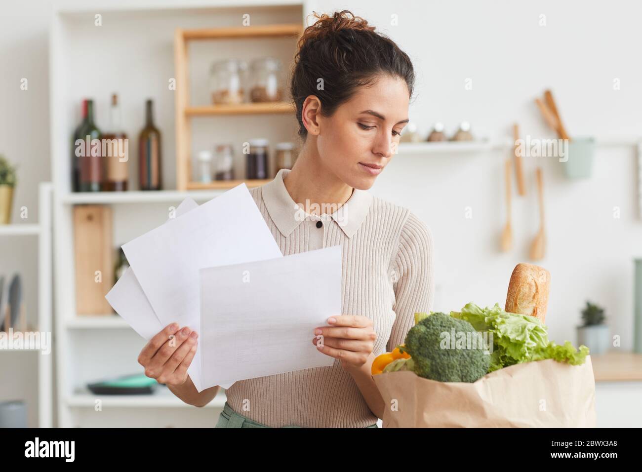 Young woman holding documents hi-res stock photography and images - Alamy