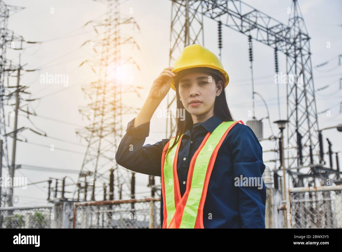 Women Engineering touching on hard hat safety standing outdoor work ...