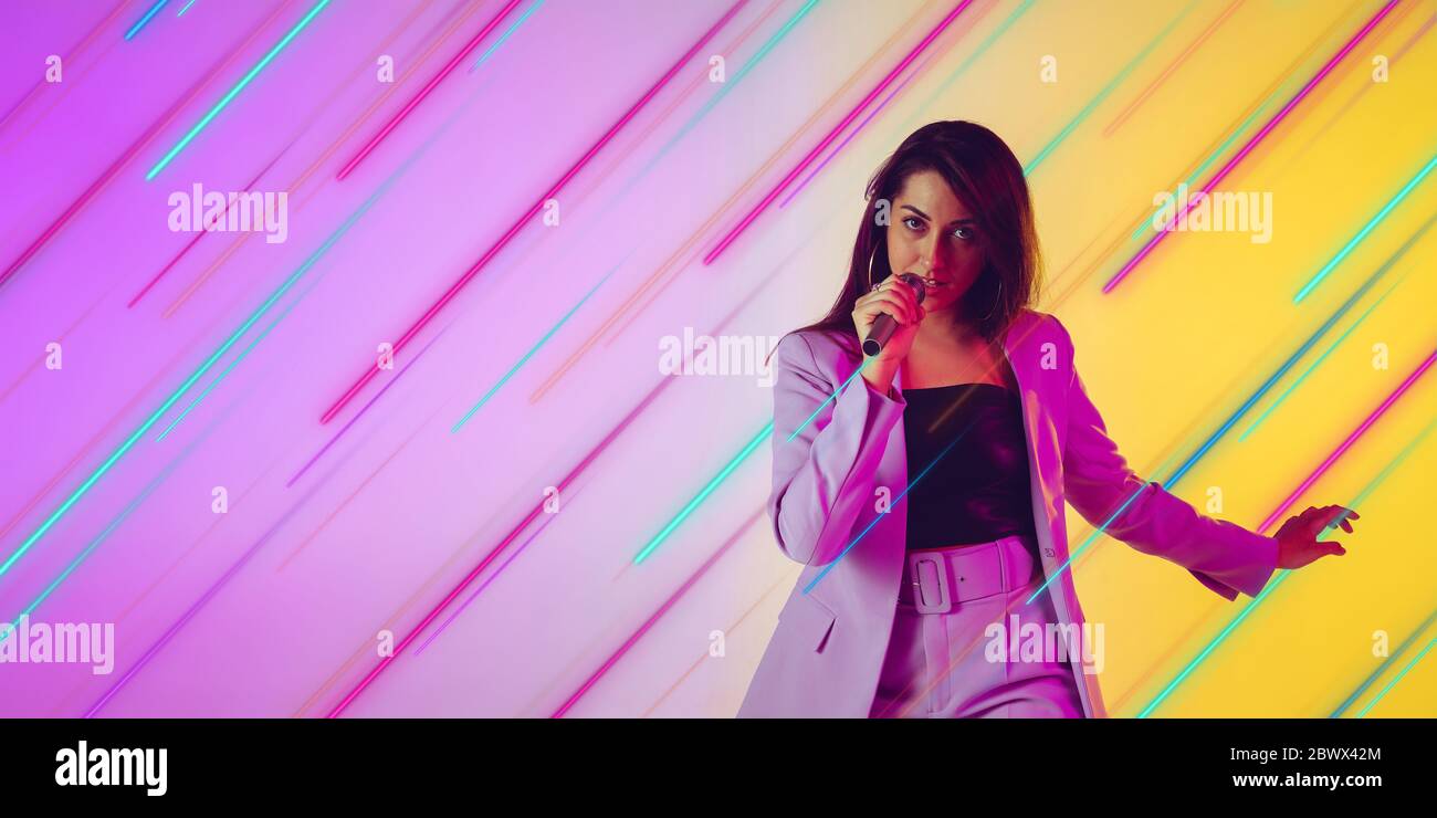Woman singing, performing. Creative portrait with copyspace. Neon ...