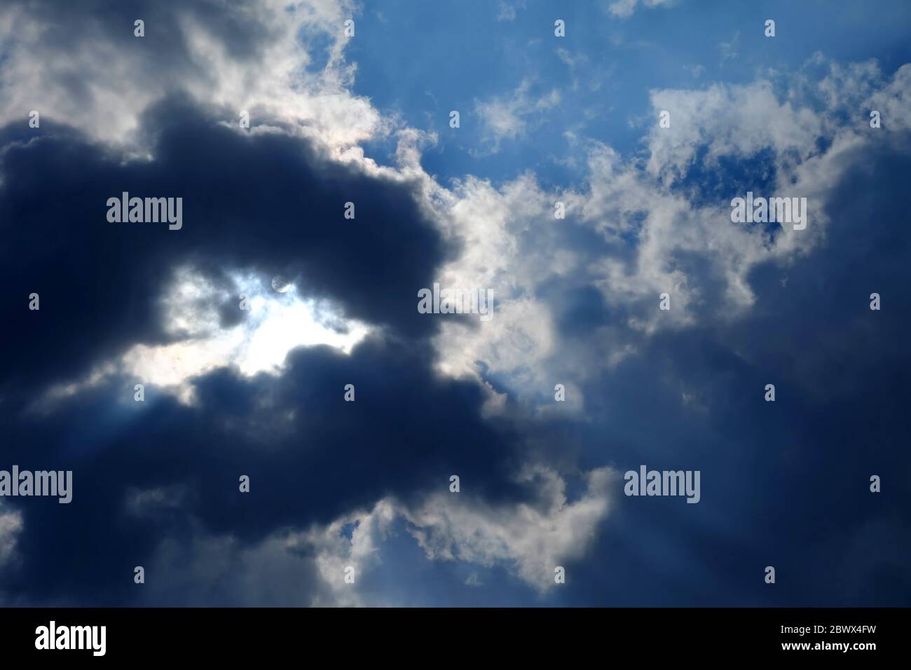 Sun Under the Clouds with Light Beams Background Stock Photo - Alamy