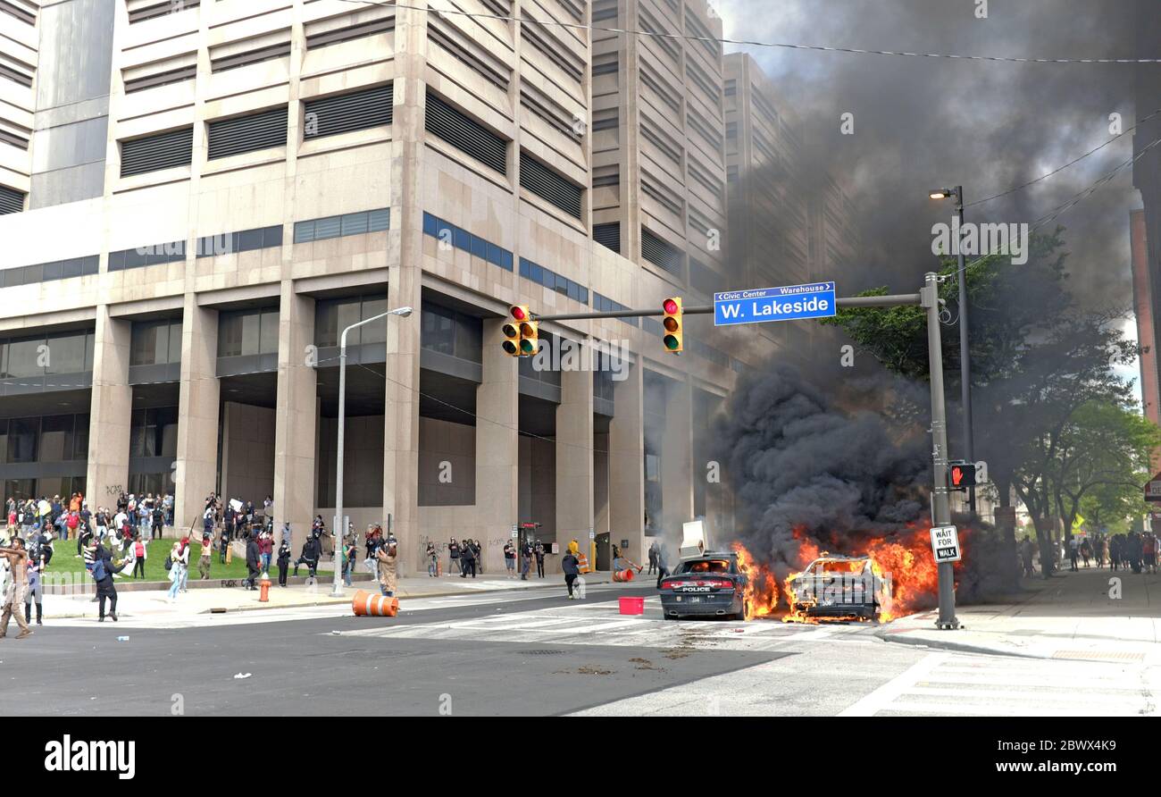 Two Cleveland police cars burn on the street outside the Justice Center ...