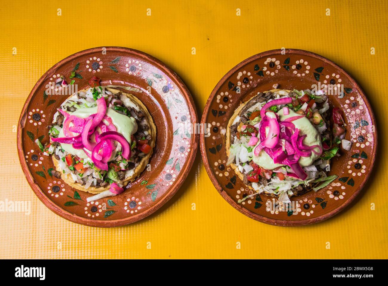 Meat sopes with guacamole and onion Stock Photo - Alamy